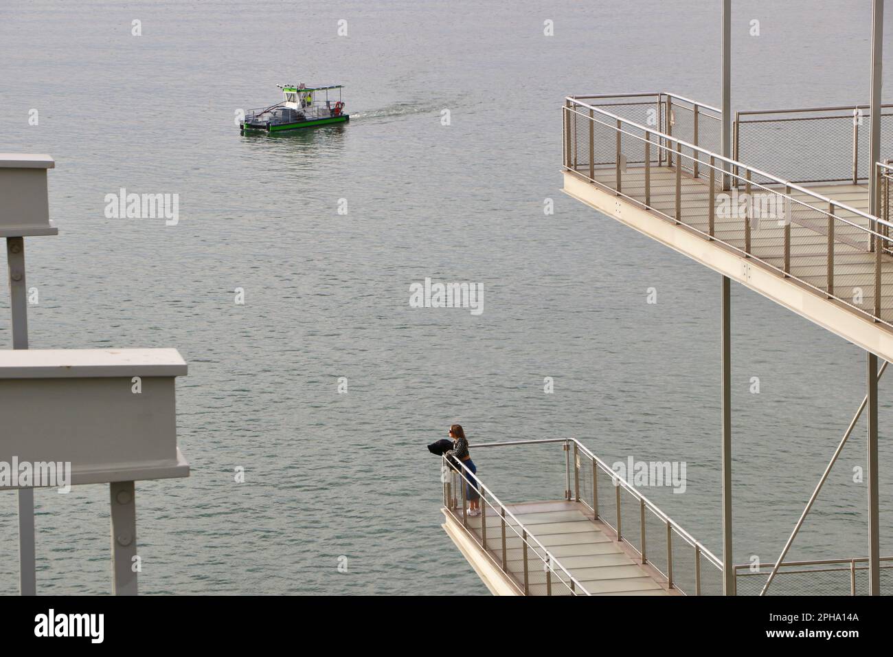 Pontoon boat from water surface cleaning company Urbaser in the bay of ...