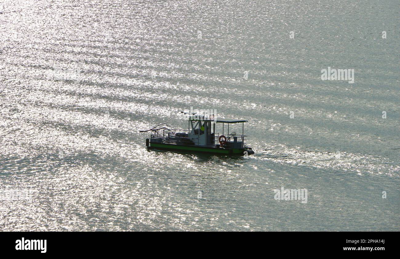 Small twin pontoon boat from water surface cleaning company Urbaser in ...