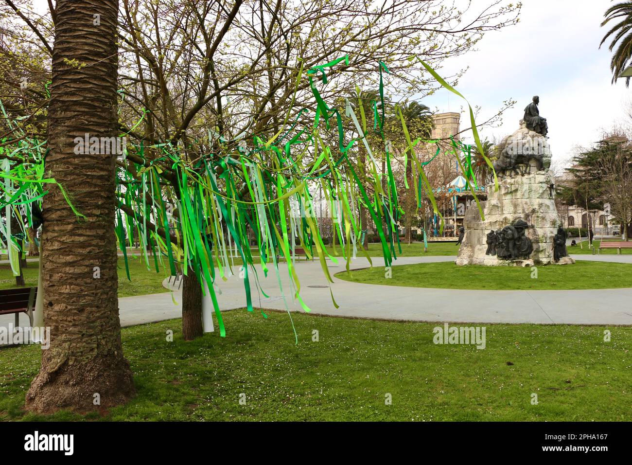 Trees decorated with green ribbons for the Tree Festival and statue ...