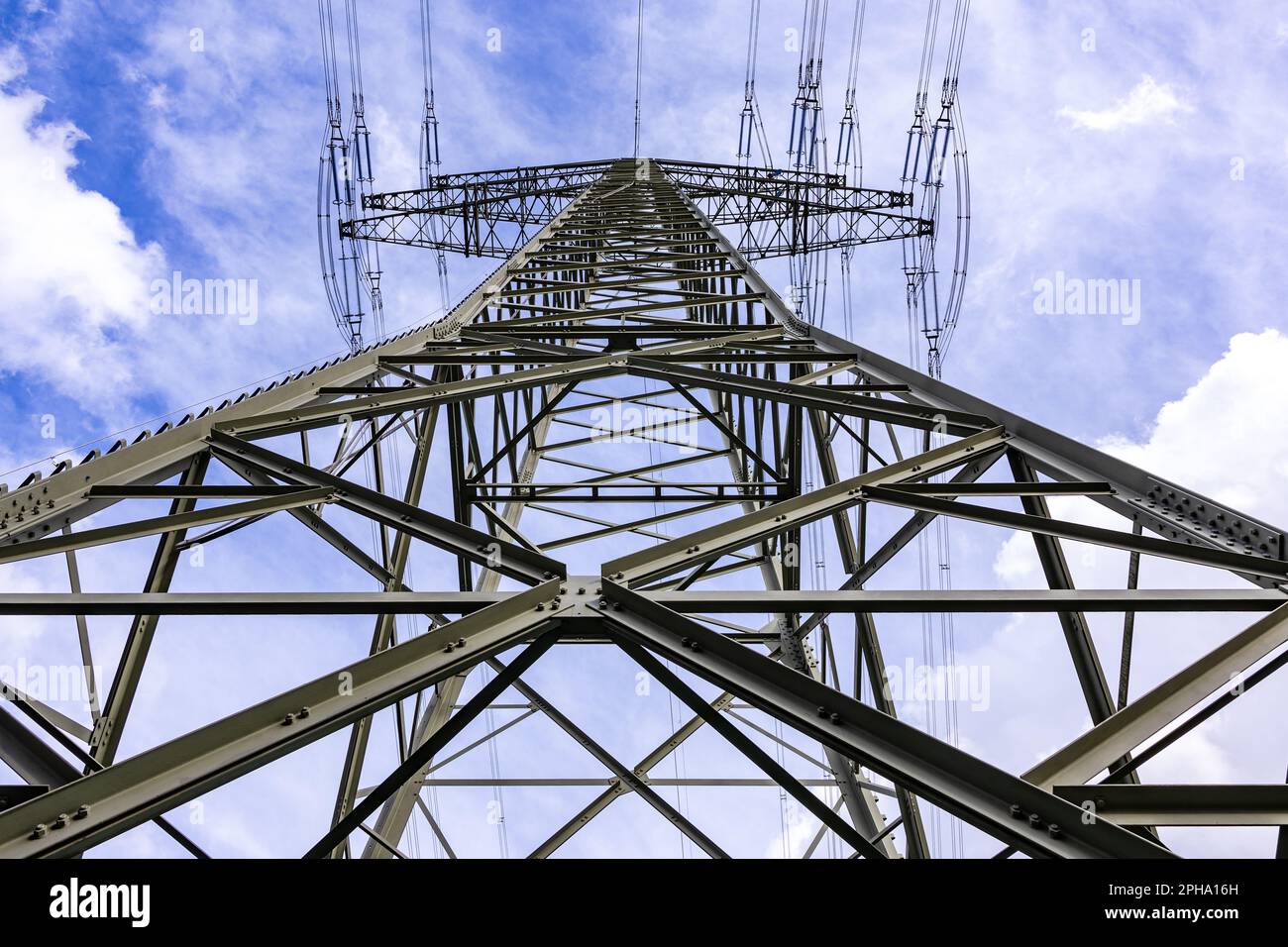 High voltage tower as steel electricity pylon with many wires against ...