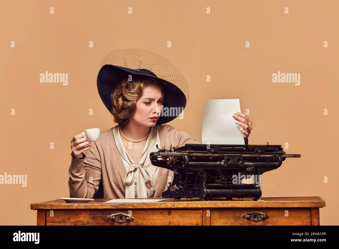 Attractive woman writer wearing old-fashioned clothes sitting at ...