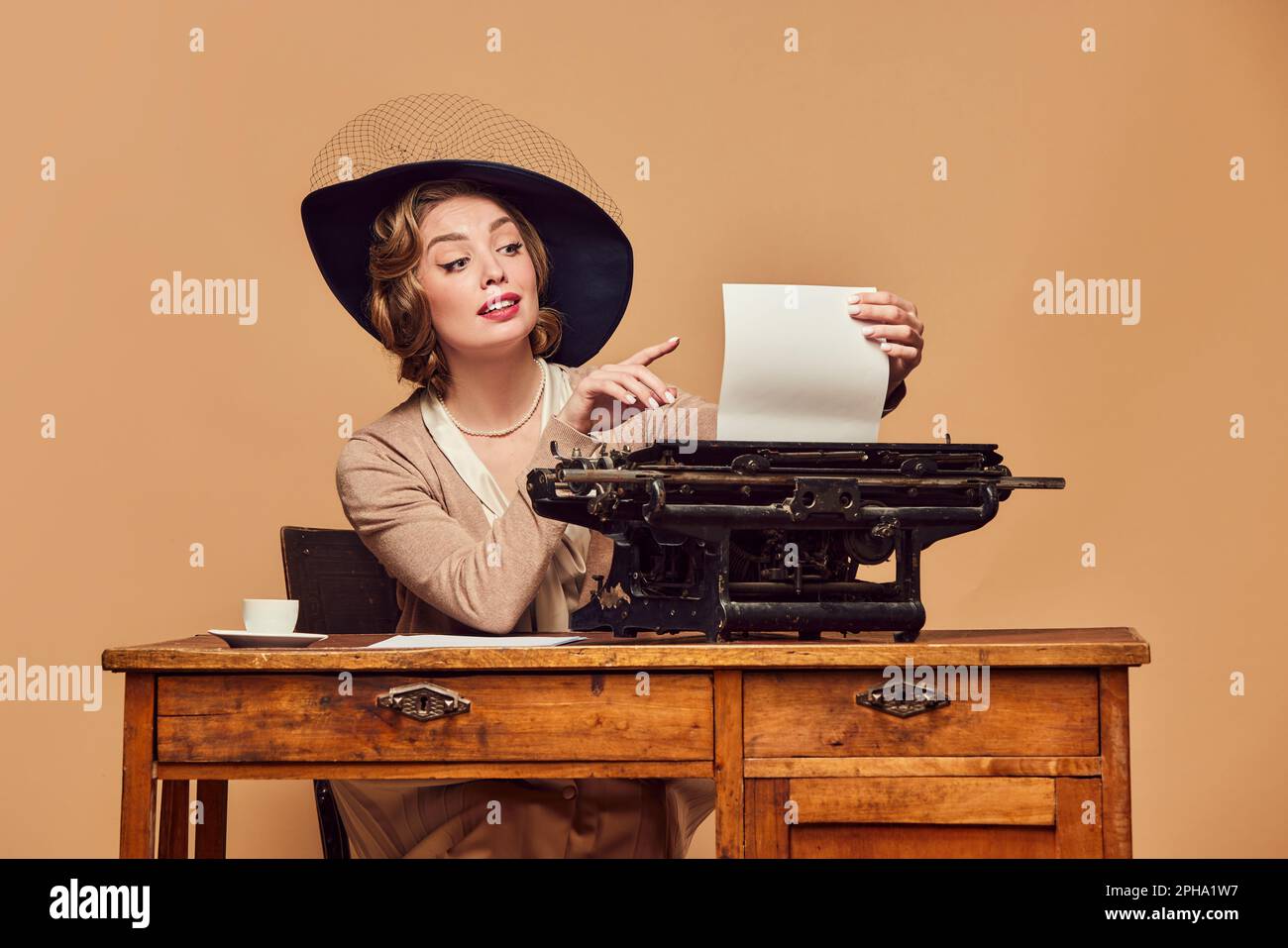 Surprised beautiful woman writer wearing retro clothes sitting at ...