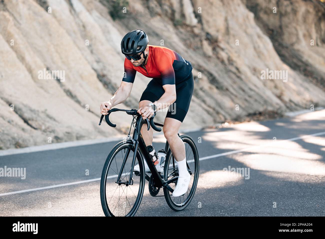 Professional male cyclist riding his bicycle outdoors Stock Photo - Alamy