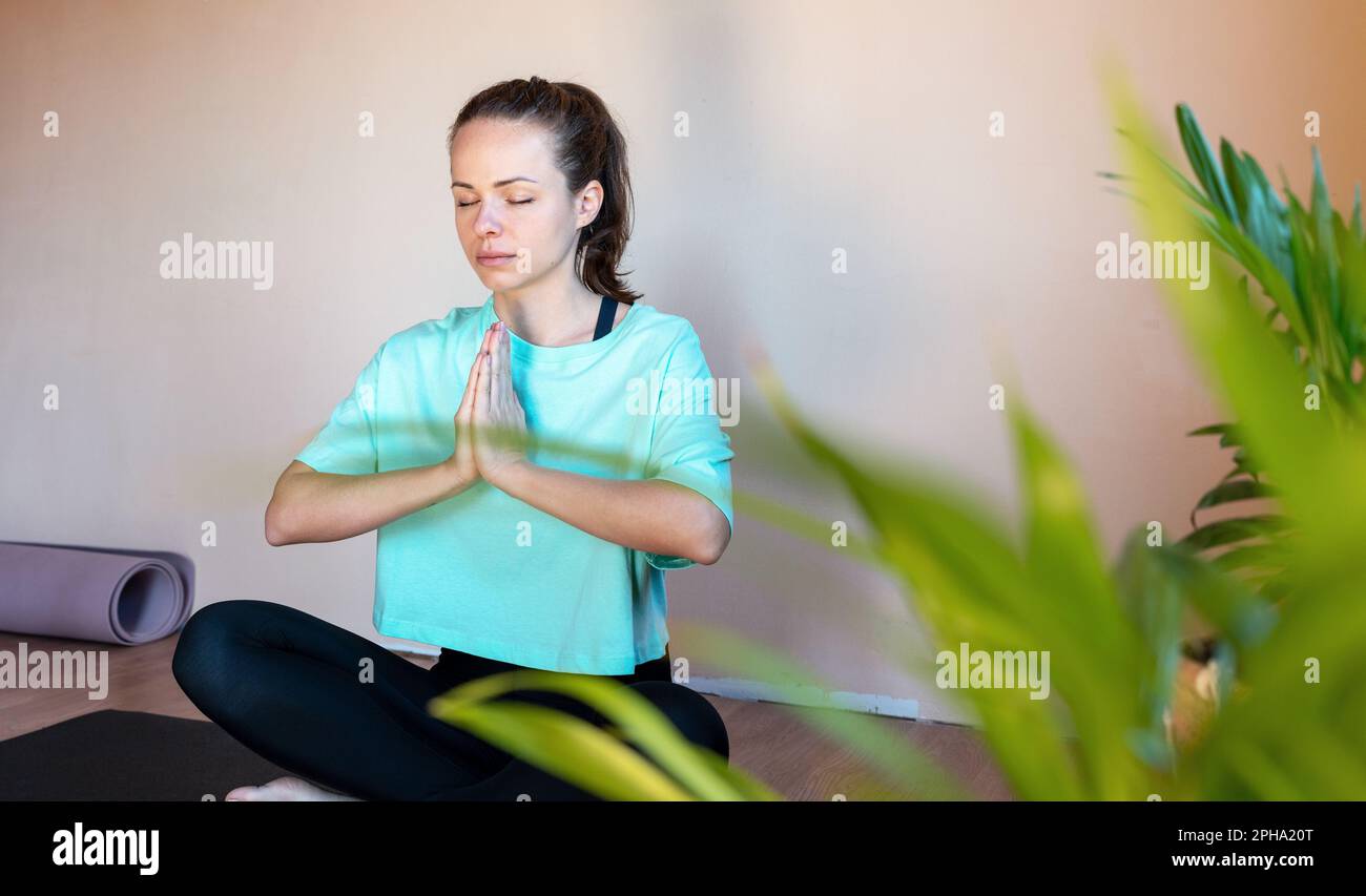 Meditating in lotus pose hi-res stock photography and images - Alamy