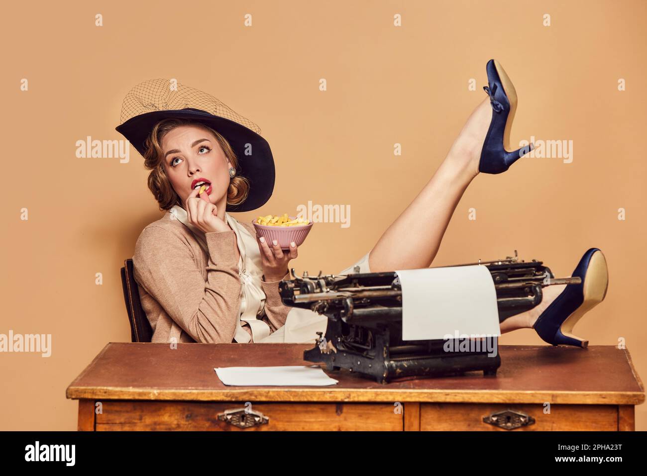 Adorable woman writer wearing heels sitting with legs up on table and ...