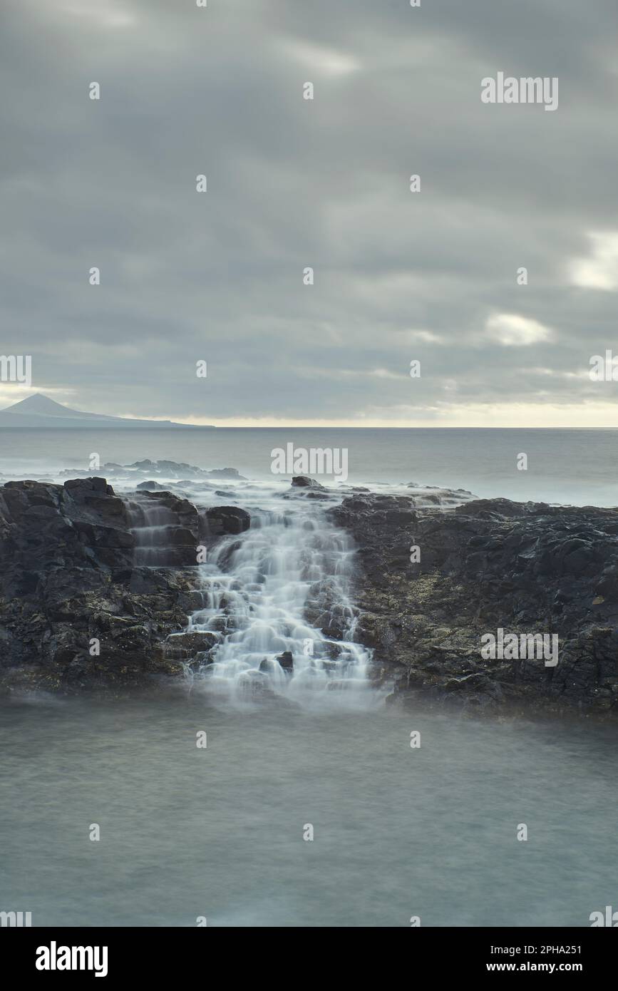 Waves over the rocks Stock Photo - Alamy