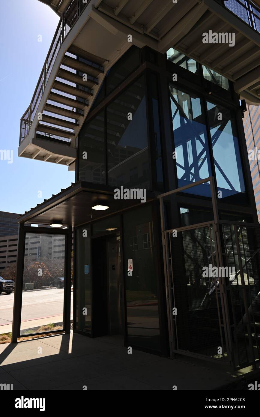 An urban high-rise office building featuring metallic and glass ...