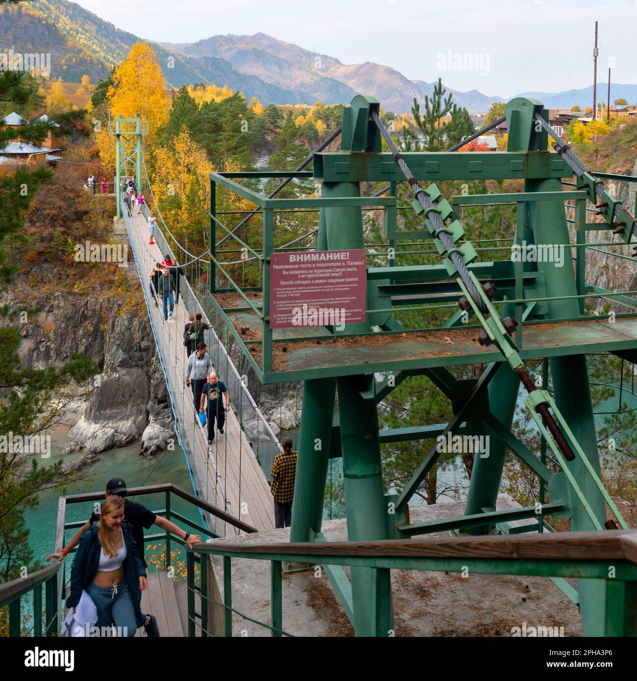 Many tourists walk along the suspension bridge to the island to see the ...