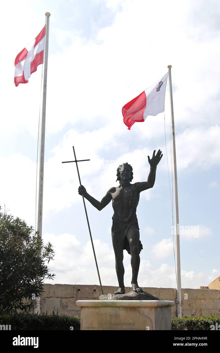 Statue of Saint Jean Baptiste (St John the Baptist) & the flags of the ...