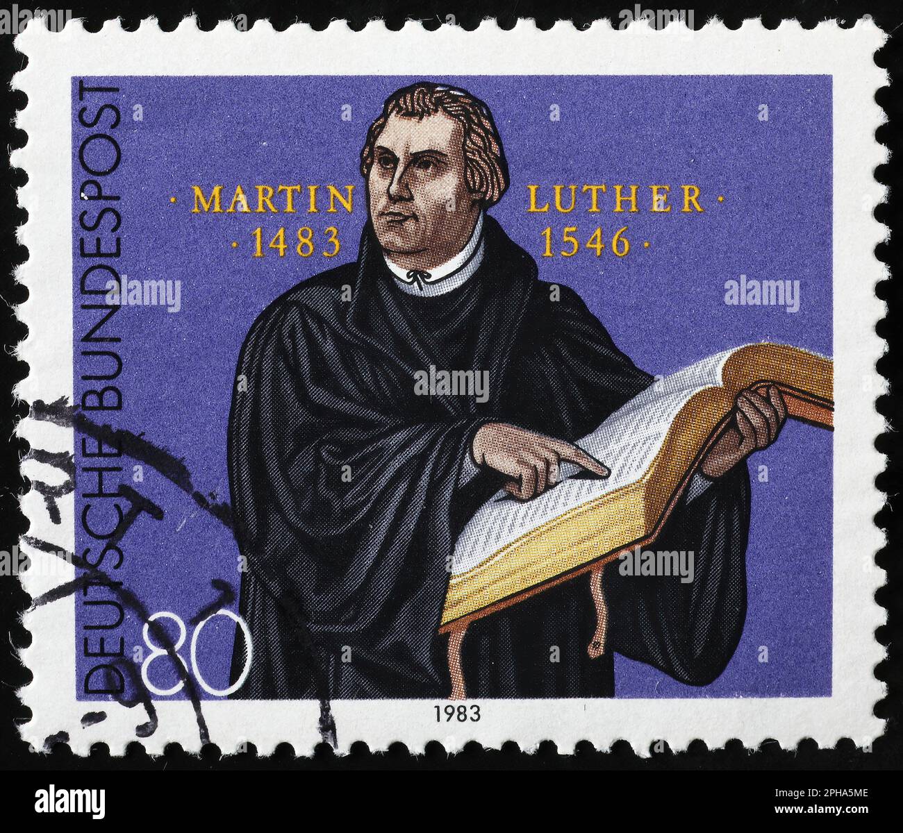 Martin Luther and the bible on german postage stamp Stock Photo - Alamy