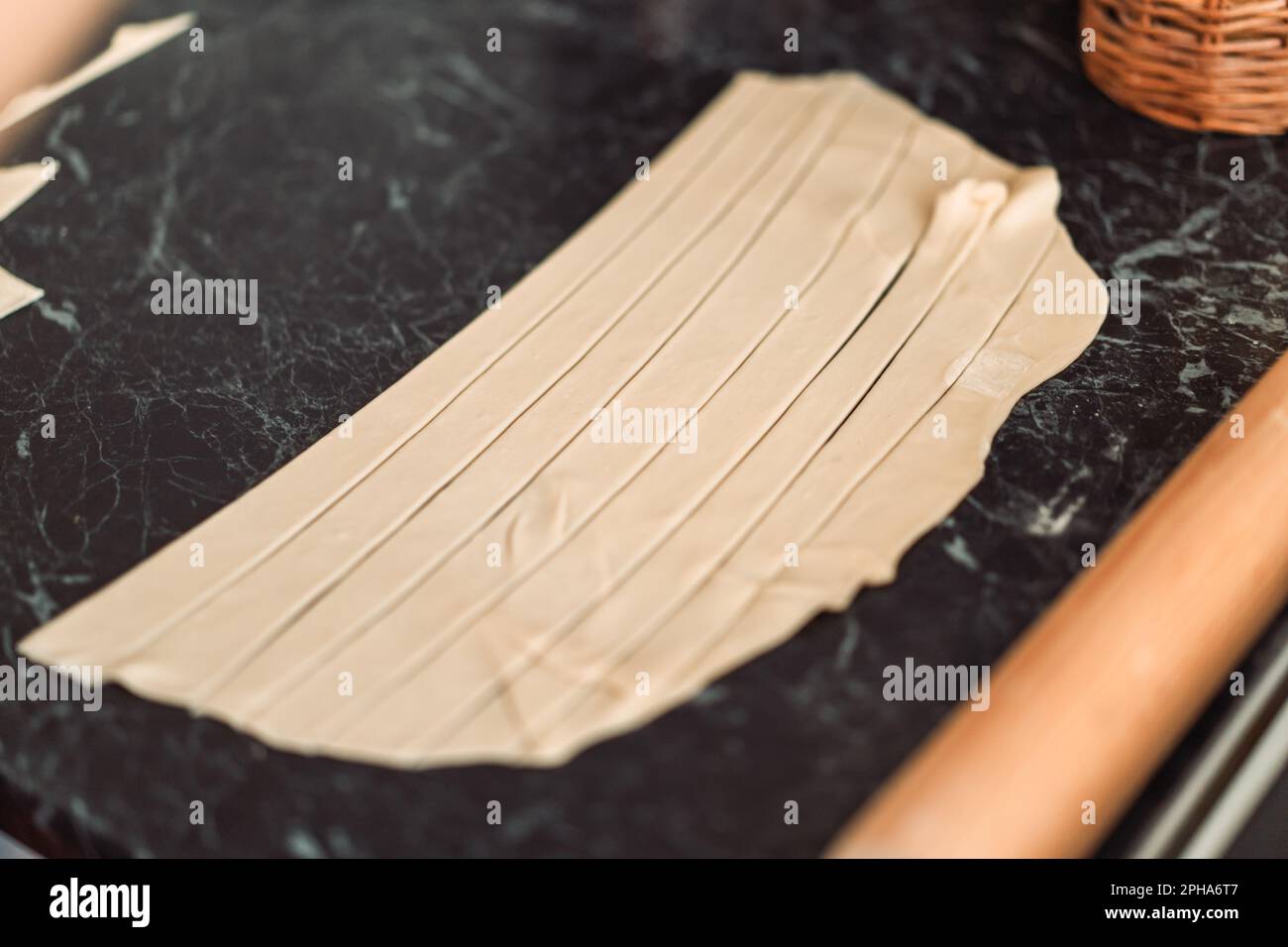Puff pastry cut into strips on a tabletop Stock Photo - Alamy