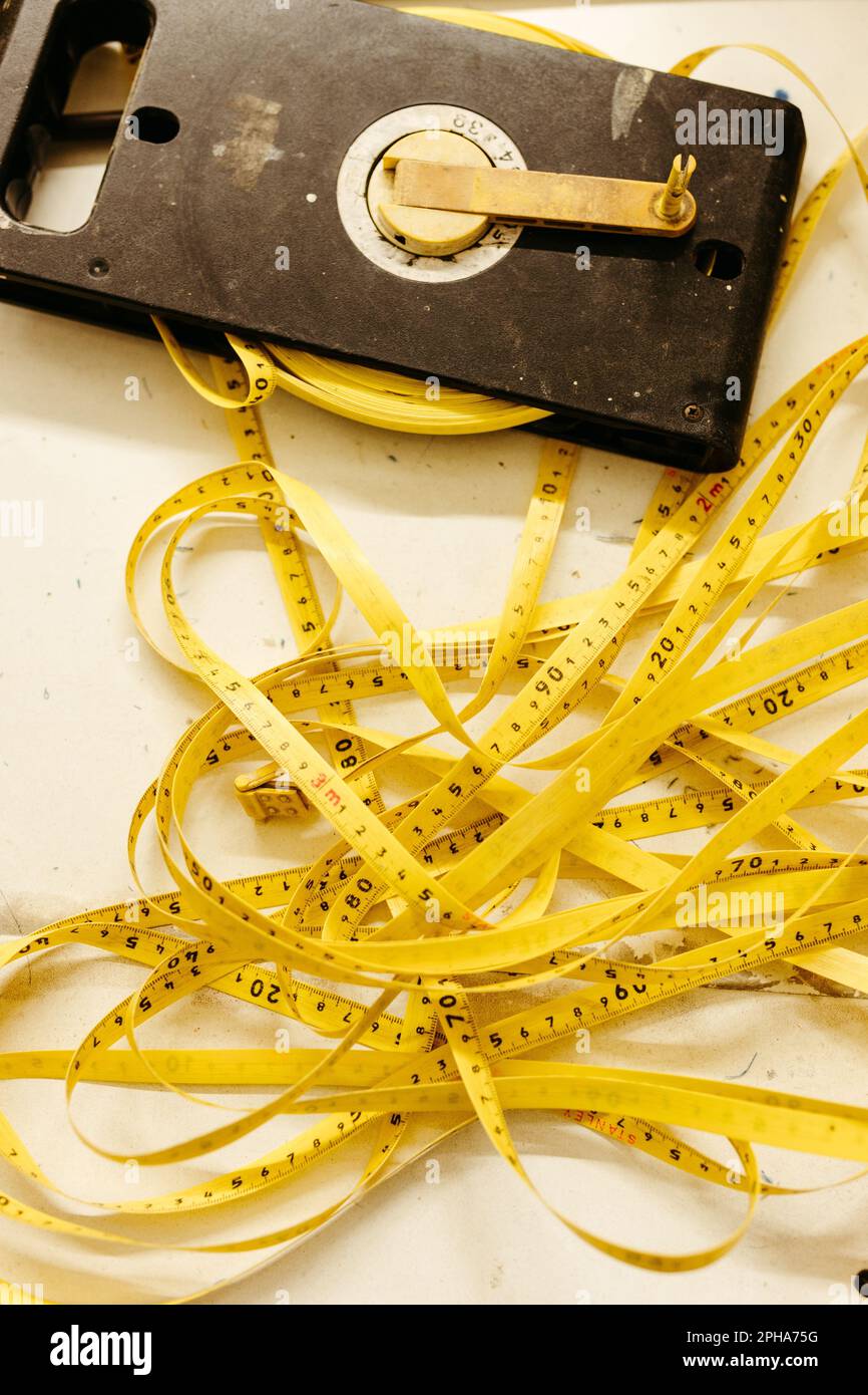 A vertical photograph of a measuring tape with its end curled up Stock ...