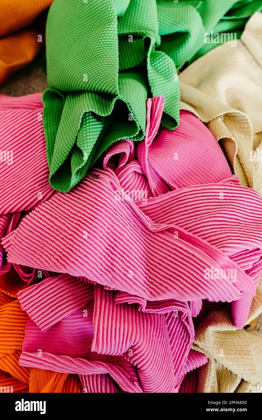 A vibrant vertical shot showcasing an assortment of fabrics, including ...