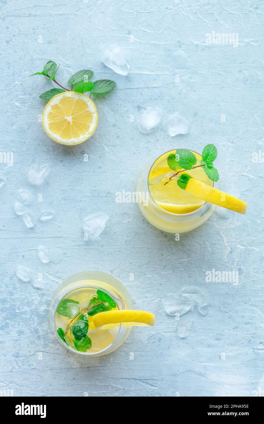 Lemonade with mint. Lemon water drink with ice. Two glasses and a ...