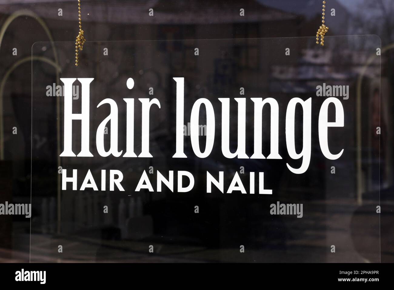 Sign saying "Hair Longue. Hair Nad Nail" in the window of haidresser ...