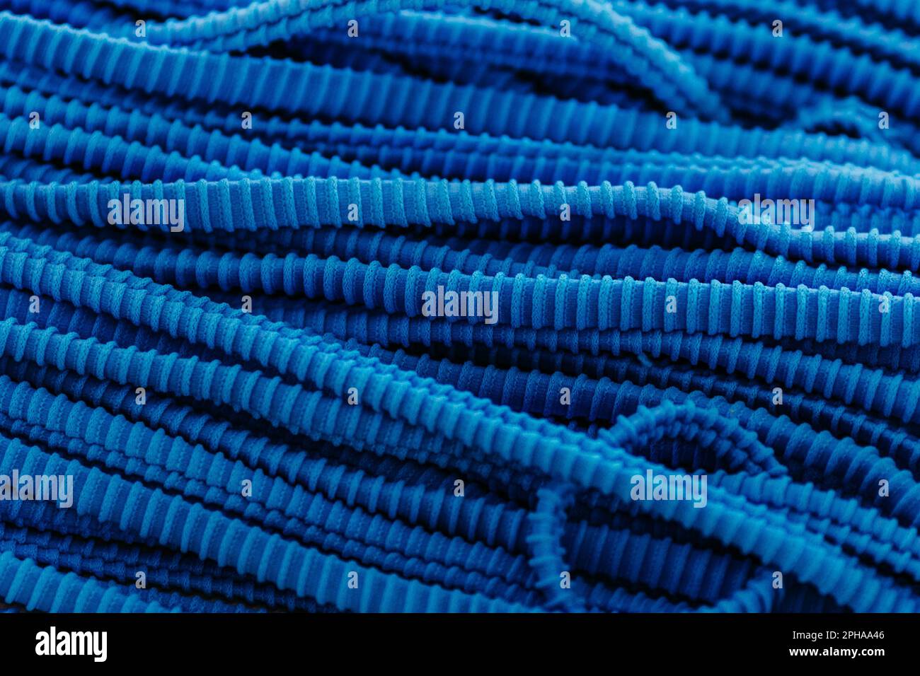 A blue and dark background featuring a cloth-like texture with a ...