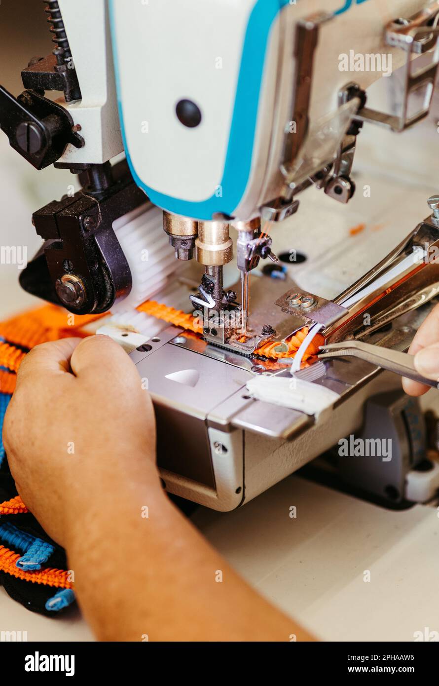 A person is using a sewing machine to craft a garment, featuring an ...