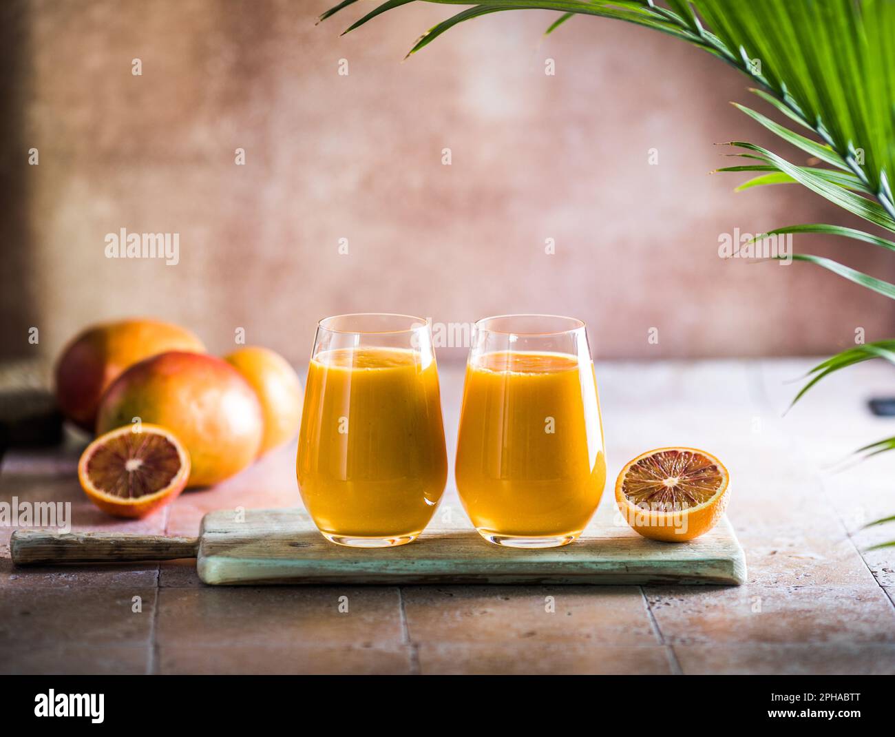 Two mango lassi or kesar milk in glasses. Indian healthy ayurvedic cold ...