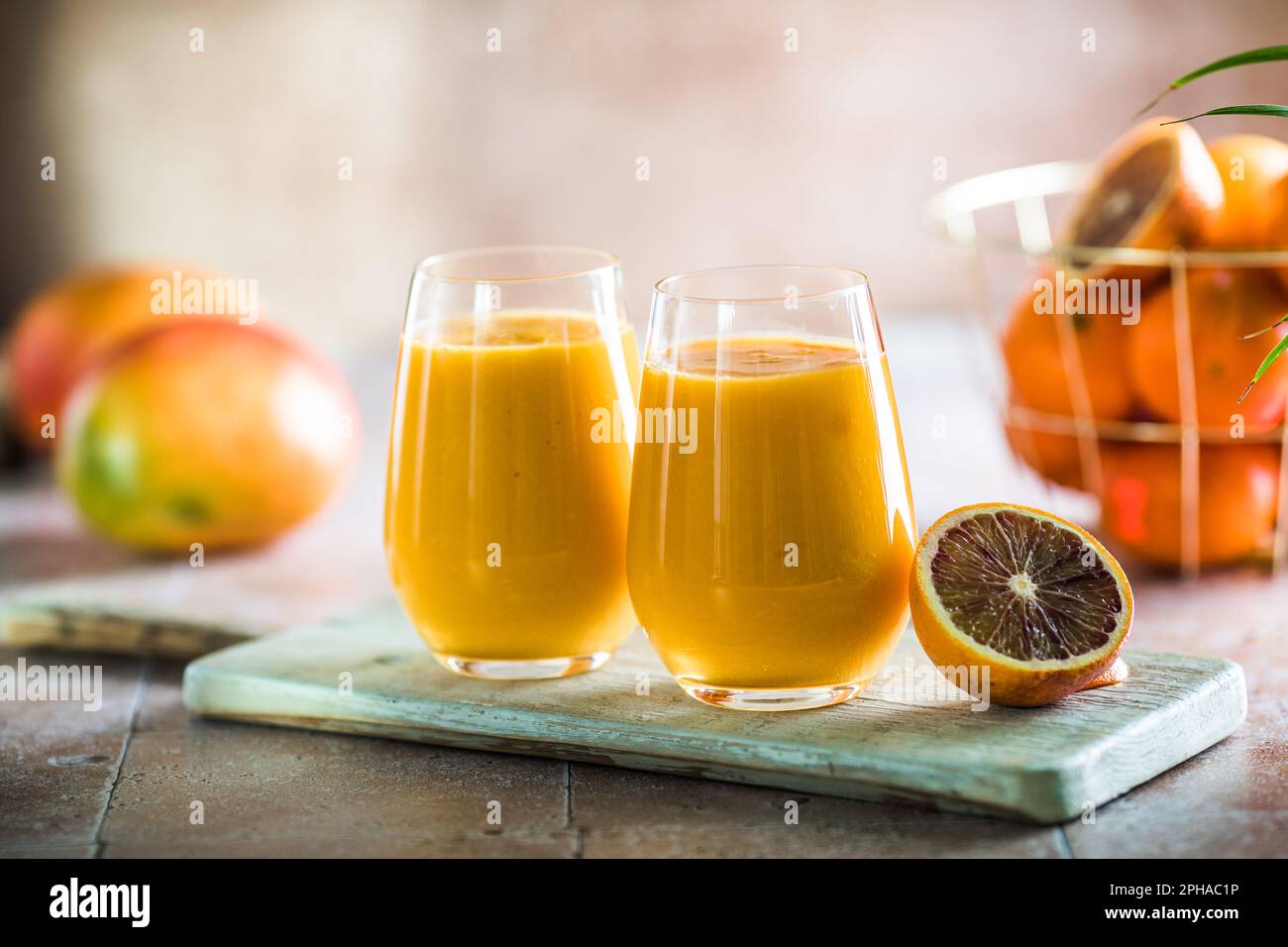 Two mango lassi or kesar milk in glasses. Indian healthy ayurvedic cold ...