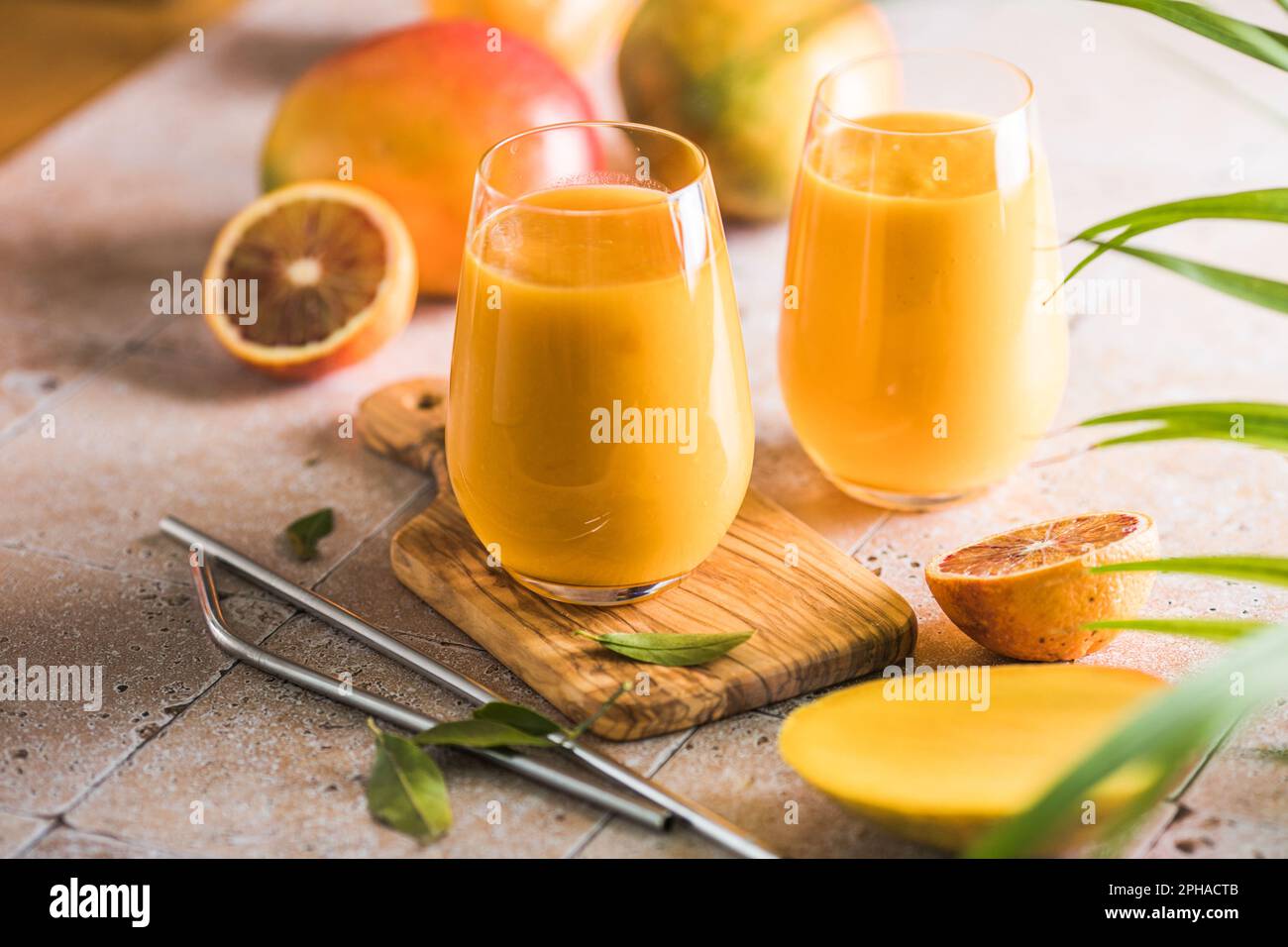 Two mango lassi or kesar milk in glasses. Indian healthy ayurvedic cold ...