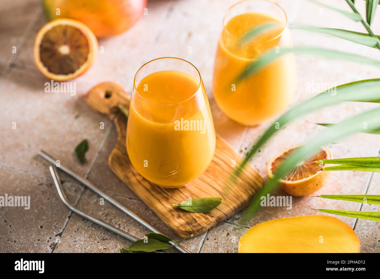 Two mango lassi or kesar milk in glasses. Indian healthy ayurvedic cold ...