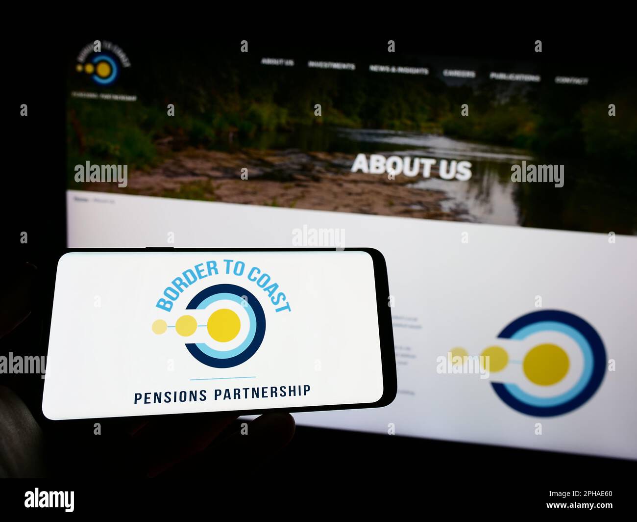 Person holding mobile phone with logo of British Border to Coast ...