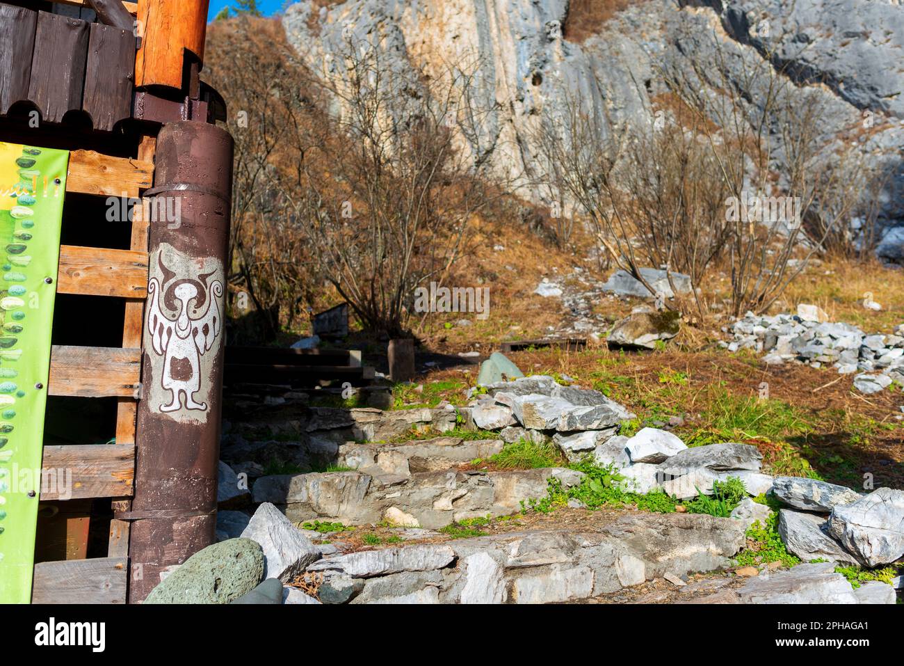 Drawing of a deity on a pillar near a rock in Altai Stock Photo - Alamy