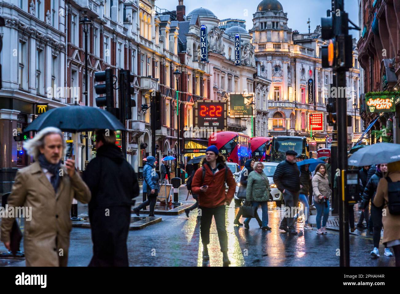 People walking in rain in Shaftesbury Avenue, a famous street in the ...