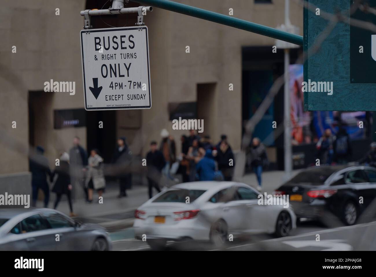 A selective focus of a "buses and right turns only" traffic sign with a ...