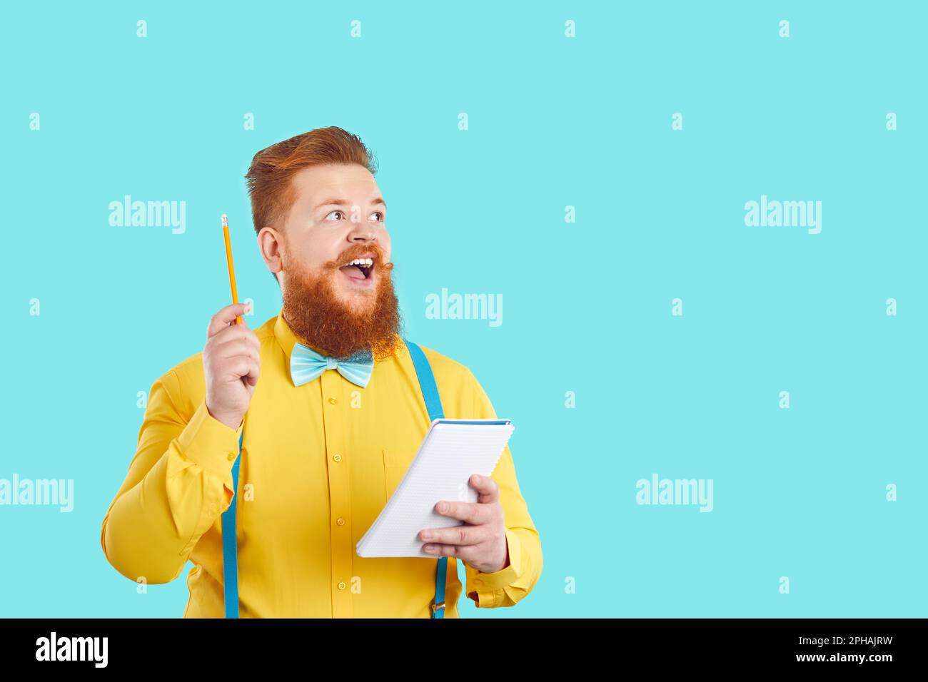 Funny happy man on copy space background thinking and writing good ...