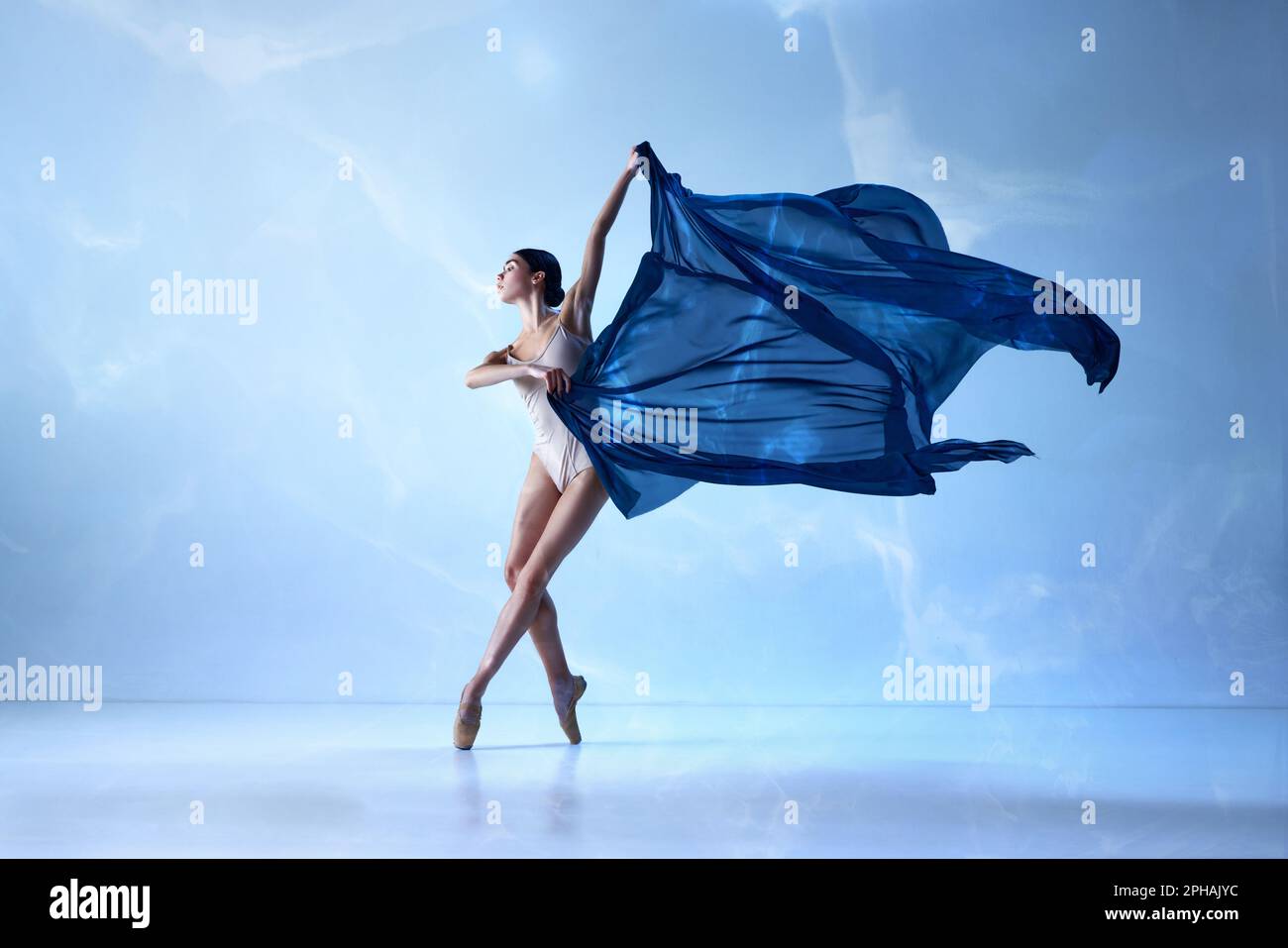 Beautiful ballerina wearing beige bodysuits emotional dancing with ...