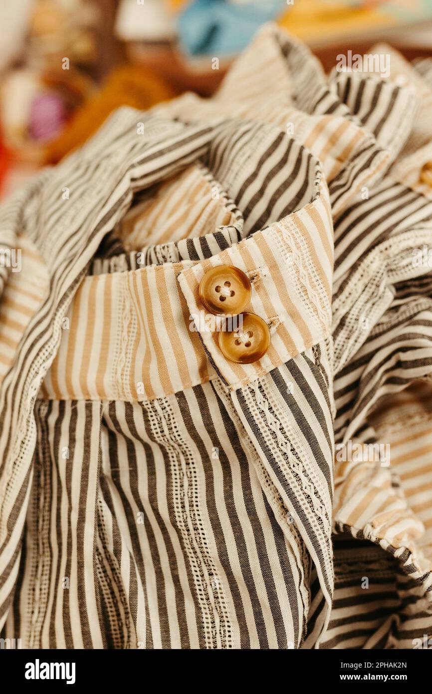 An assortment of clothing items with buttons, arranged in a display on ...