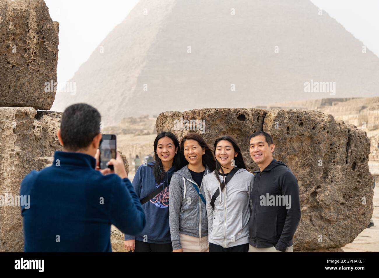 A family having their photo taken with the Pyramid of Khafre in the ...
