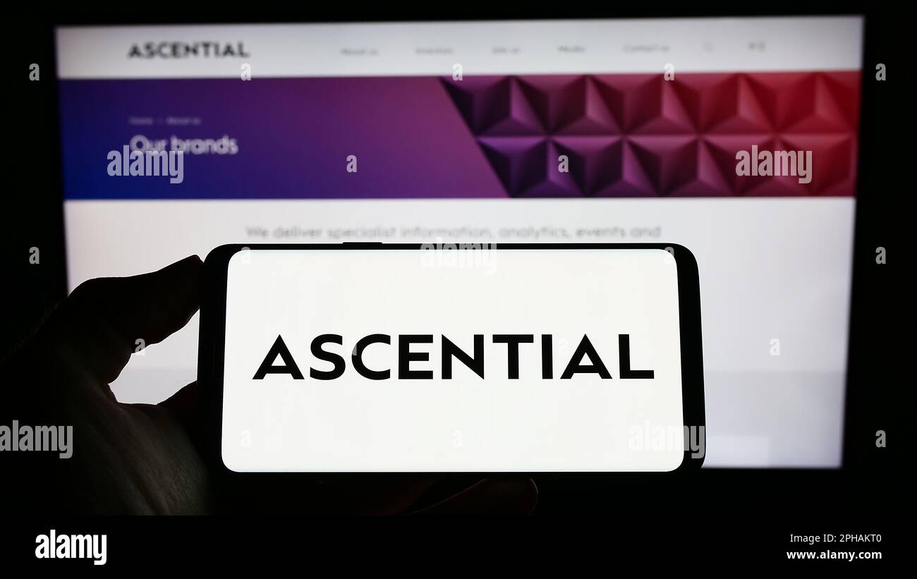 Person holding smartphone with logo of British media analytics company ...