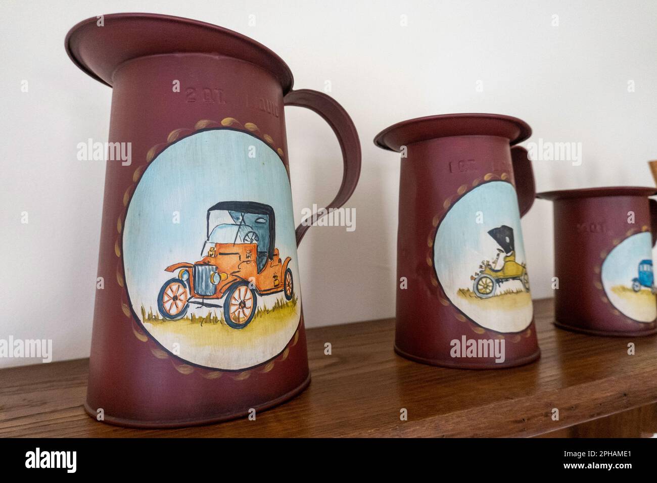 Close-up of a set of three antique measuring cans with tole painted ...