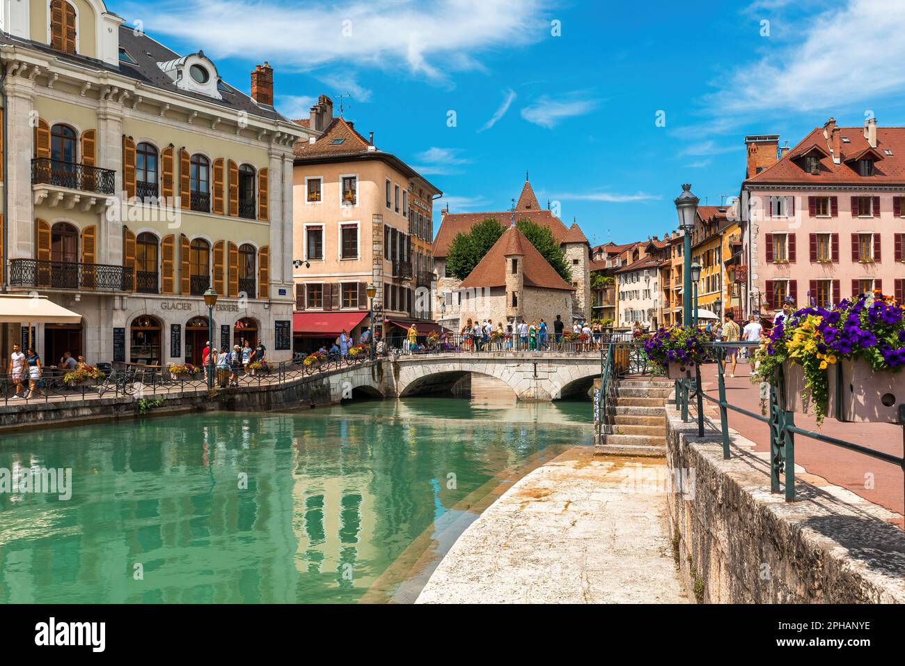 View of canal along promenade with outdoor restaurants and colorful ...