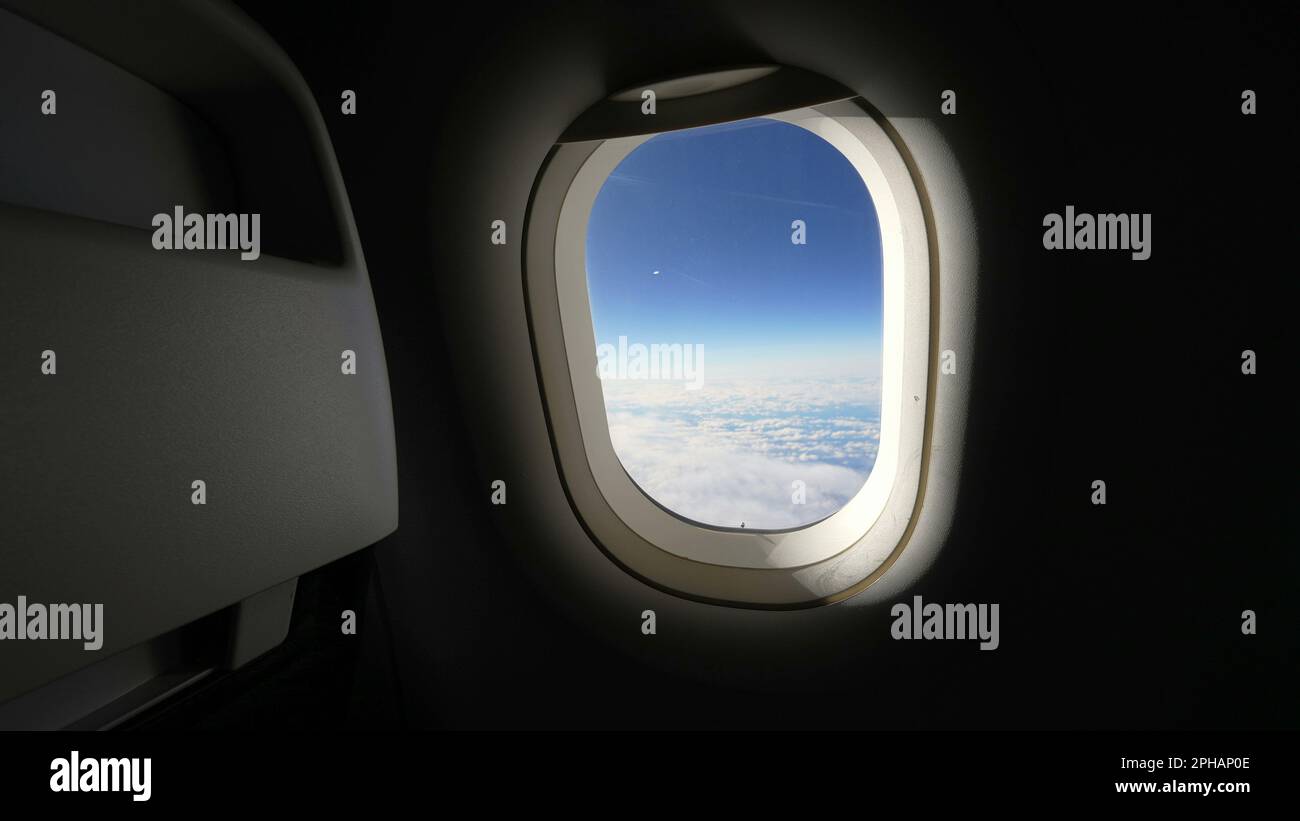 Airplane window in the air high above. Passenger plane POV looking out ...