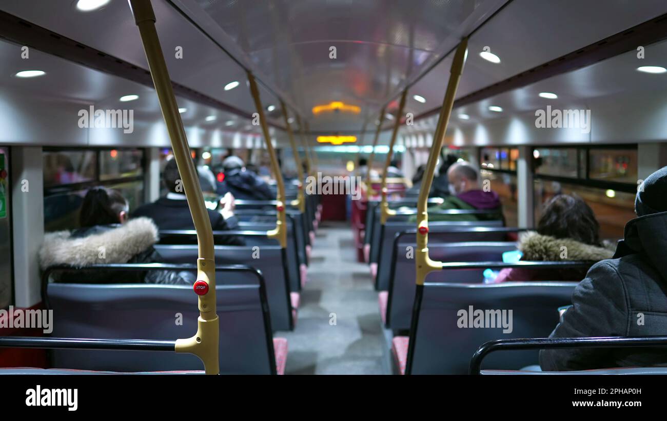 Back of bus with passengers at night in London traditional ...