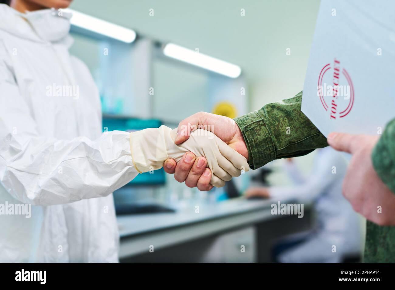 Focus on handshake of officer and young female clinician wearing white ...