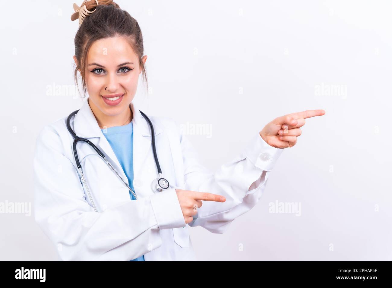 A female doctor wearing a uniform gesturing with her finger to the side ...