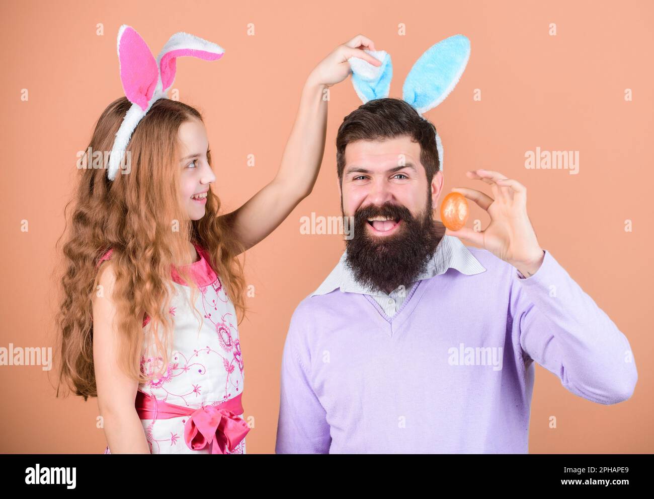 Family tradition concept. Dad and daughter wear bunny ears. Father and ...