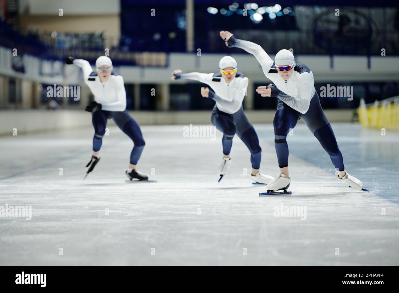Group of young male athletes in sports uniform speed skating on ice ...