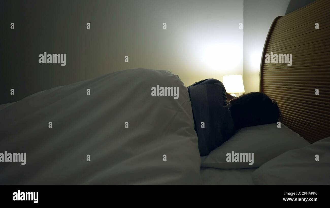 Man turning light off bedroom hi-res stock photography and images - Alamy
