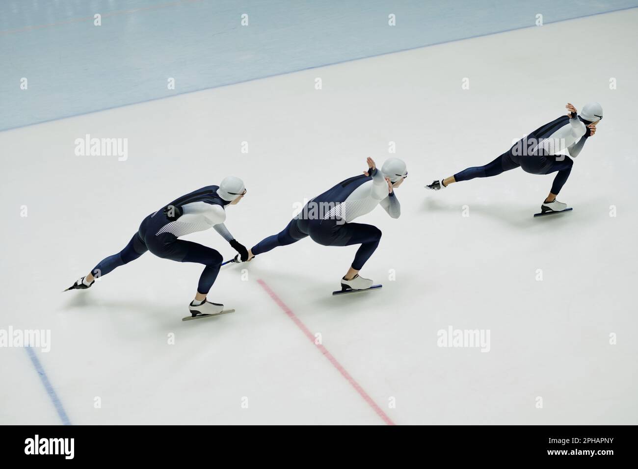 Above view of three young active athletes bending forwards while ...