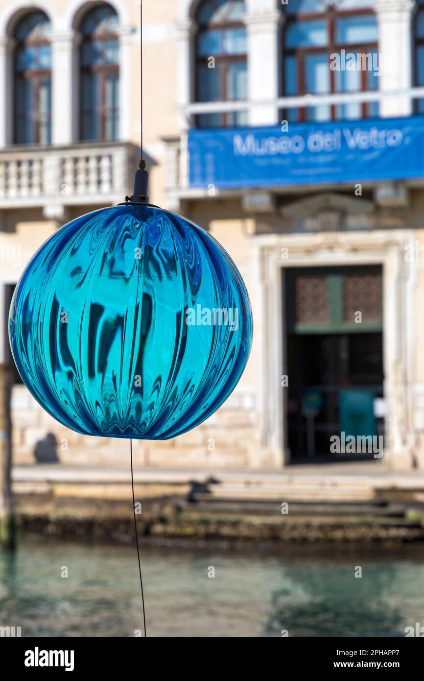 Close up of blue Murano glass light with reflections hanging opposite Museo del Vetro Murano ...