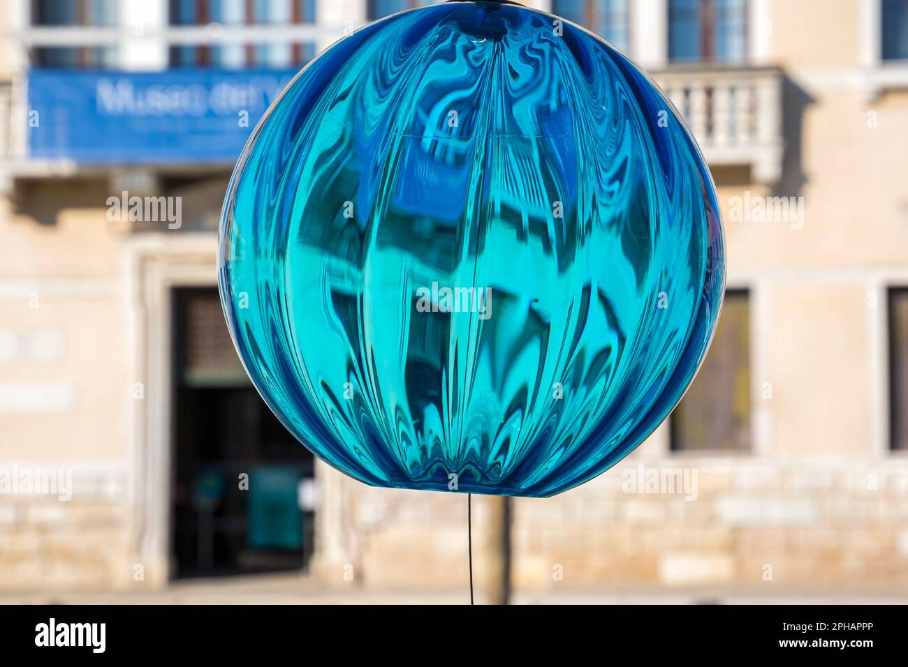 Close up of blue Murano glass light with reflections hanging opposite Museo del Vetro Murano ...