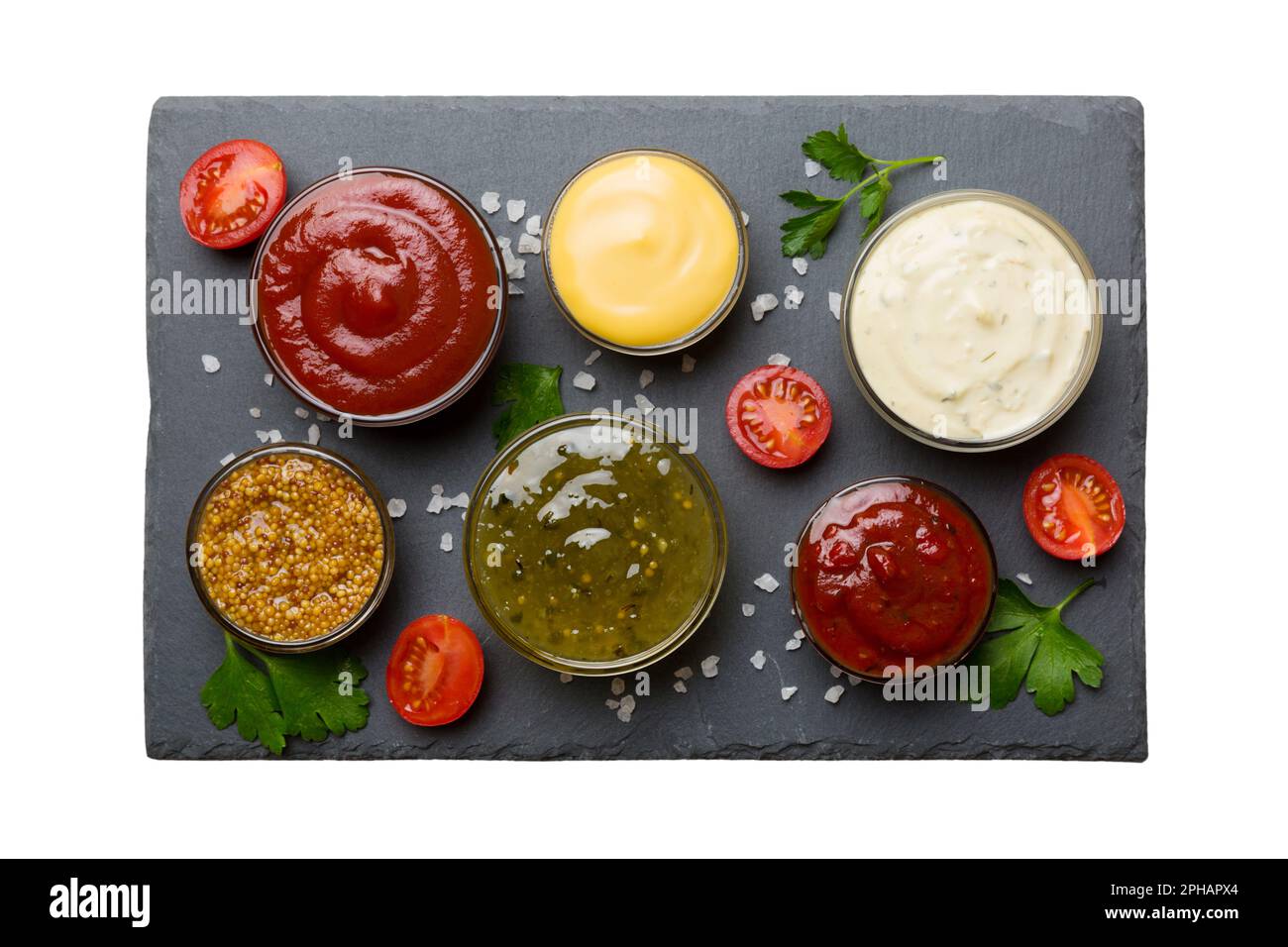Many different sauces and herbs on table, flat lay top view. sauces on ...
