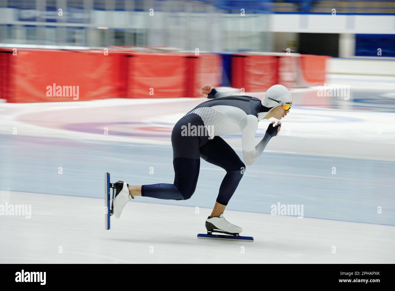 Side view of fast motion of young sportsman bending and sliding ...