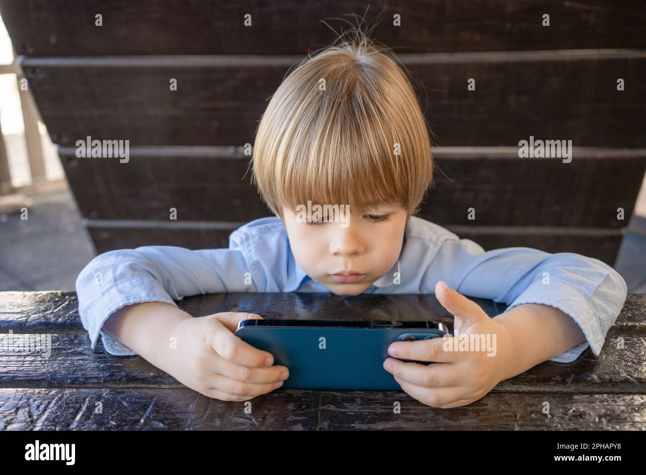 Portrait of small three years old toddler boy addictive on smartphone ...