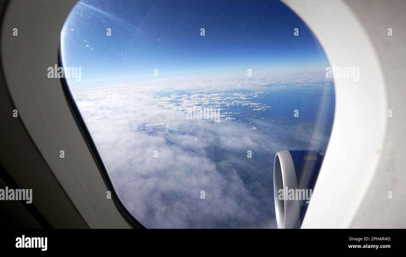 Passenger POV flying on commercial airplane with blue sky Stock Photo - Alamy
